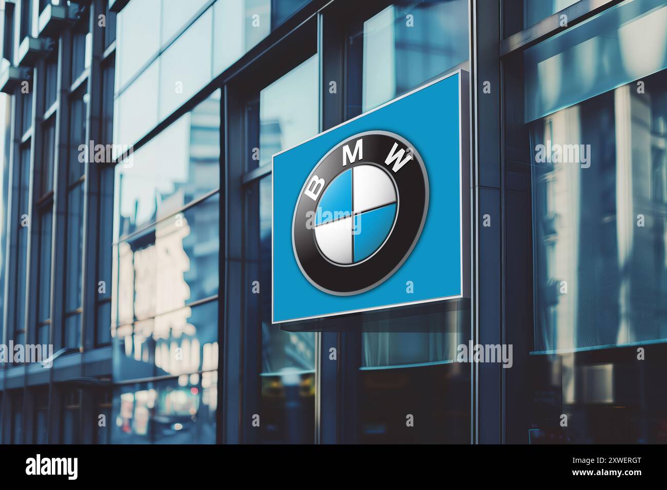 Illuminated banner with bmw car manufacturer's logo on a glass office ...