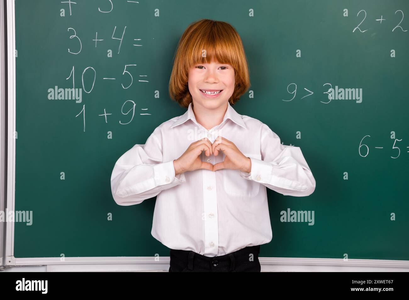 Photo of lovely small schoolboy show heart symbol dressed stylish ...