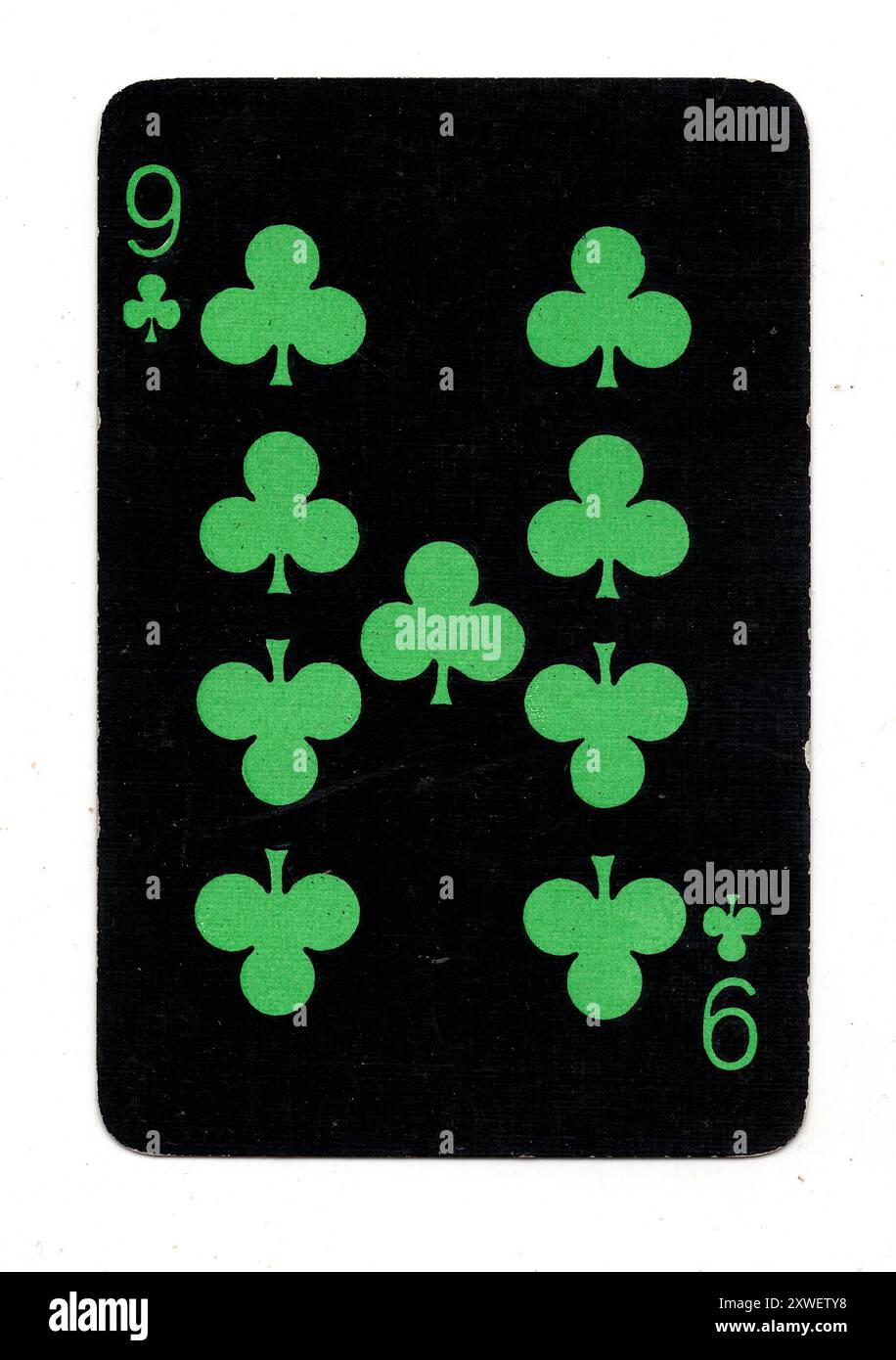 A vintage black nine of clubs playing card isolated on a white ...