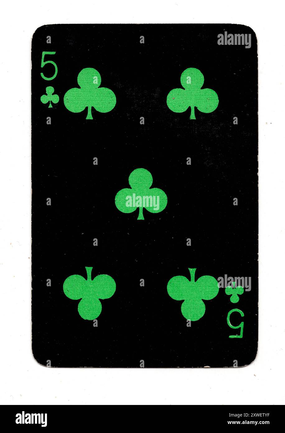 A vintage black five of clubs playing card isolated on a white ...