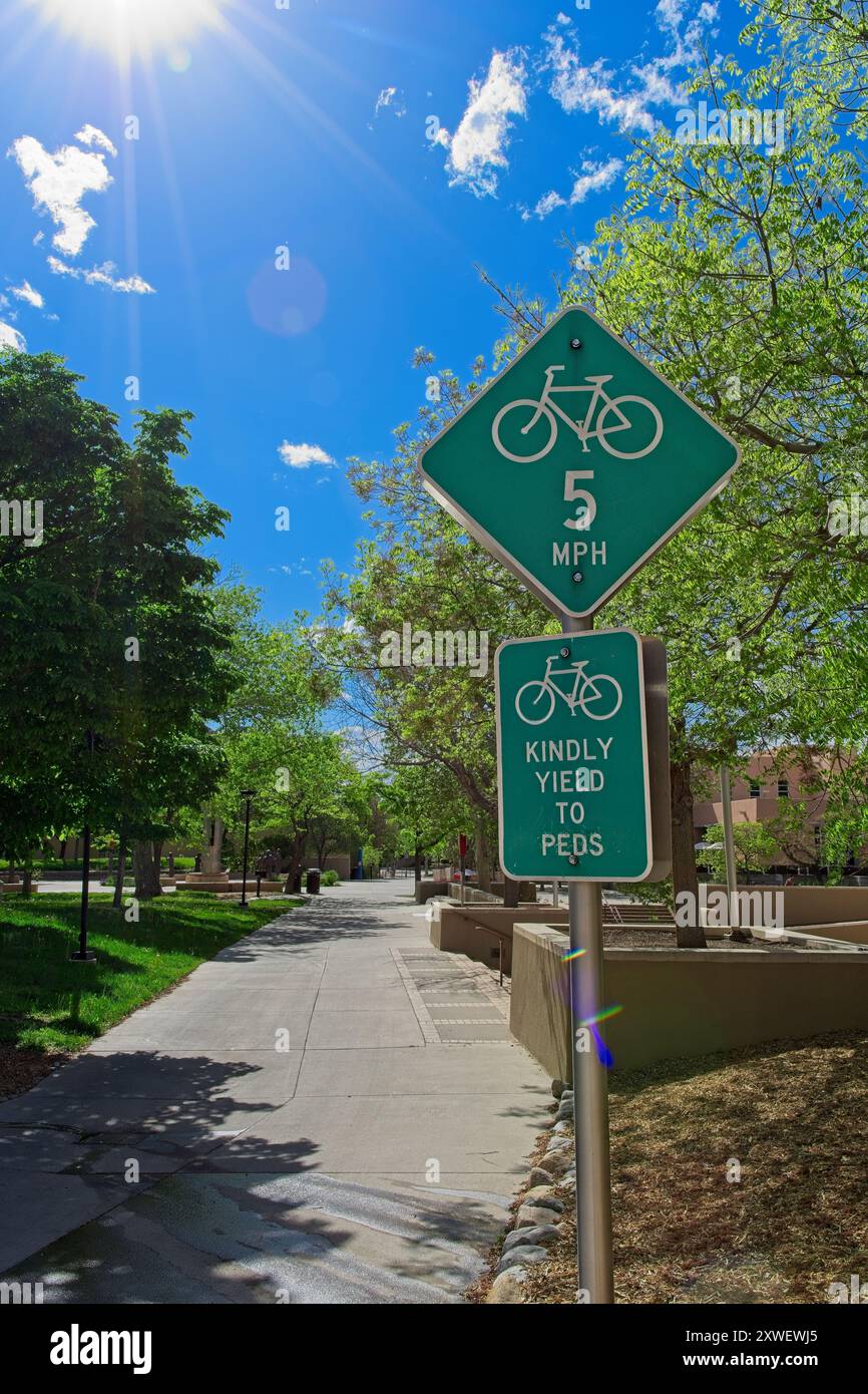 Pedestrian friendly road signs on bicycle shared campus pathway at ...