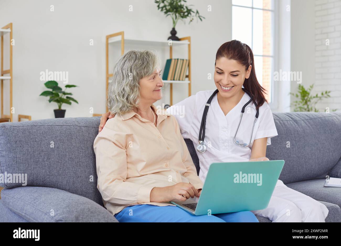 Supporting caring kind female medical nurse helping senior patient with ...