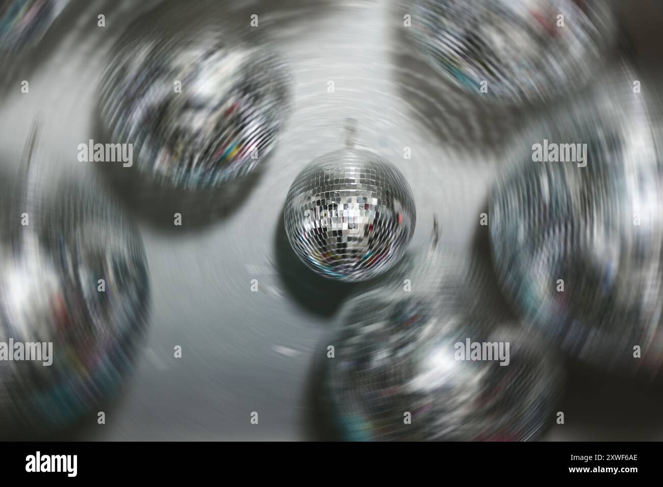 A view of several hanging disco balls, featuring a spinning effect ...