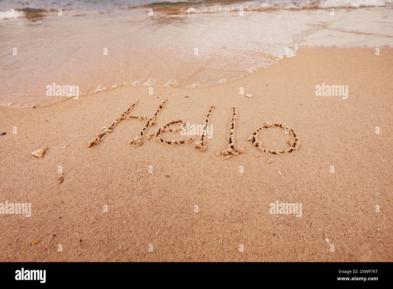 the inscription hello on the seashore with palm trees Stock Photo - Alamy