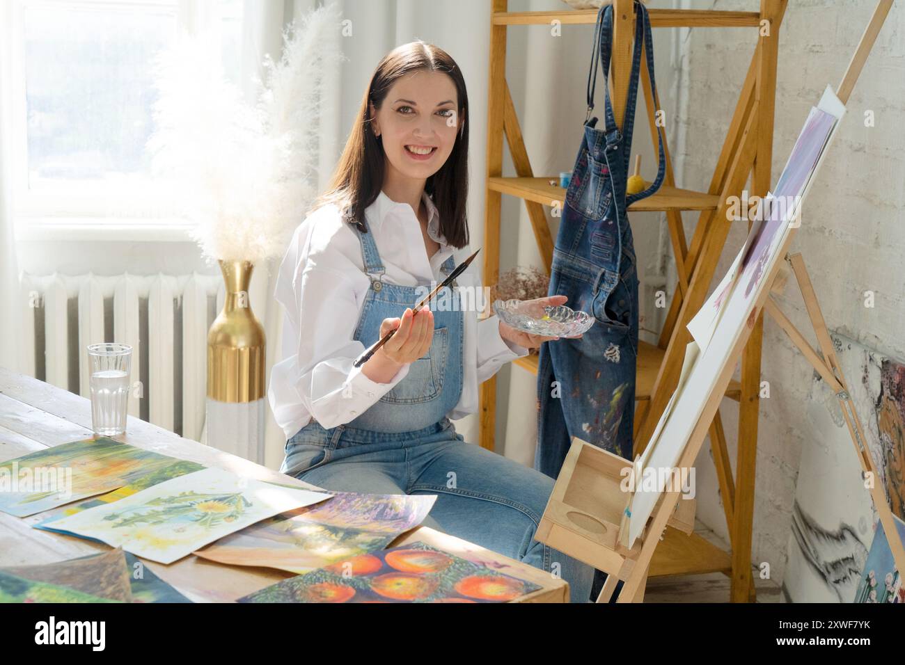 A Creative Artist is diligently at work in a bright and vibrant studio ...