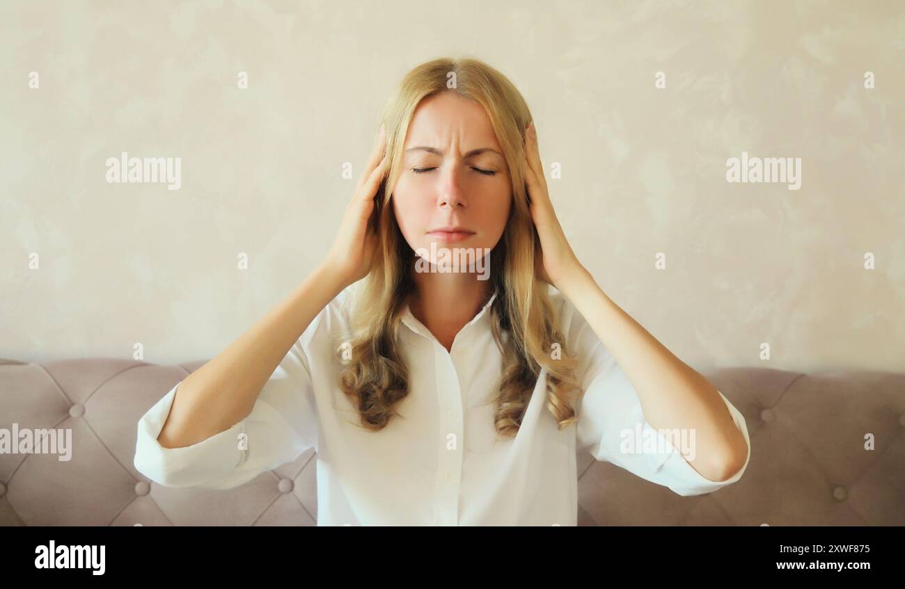 Exhausted tired woman touching head, suffering from headache, stress ...