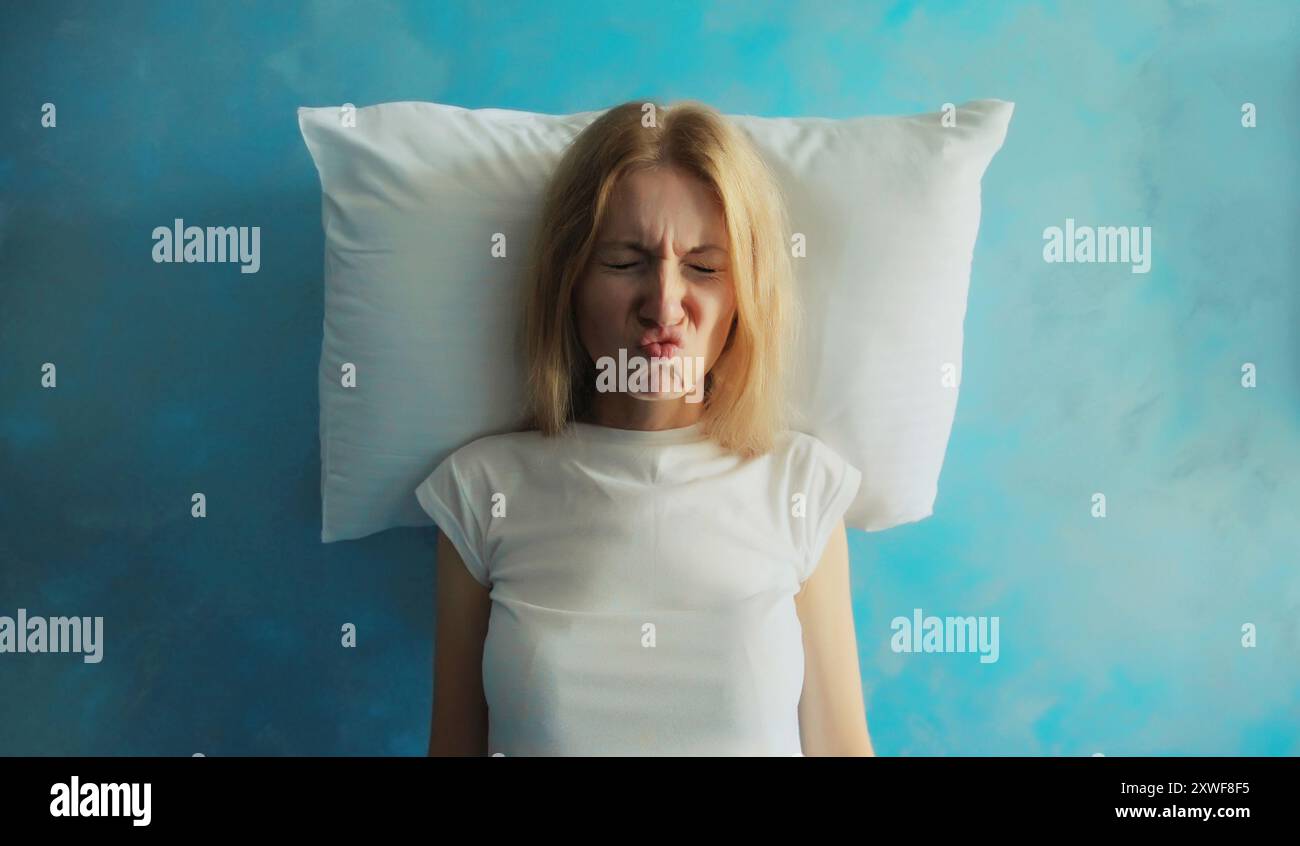 Upset sad crying woman closed her eyes lying on the pillow while ...