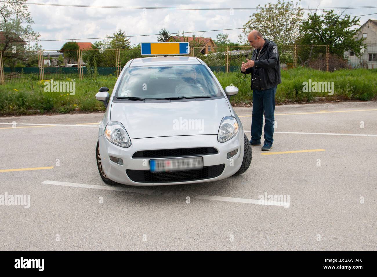 Driving instructor teaching young girl how pass the exam Stock Photo ...