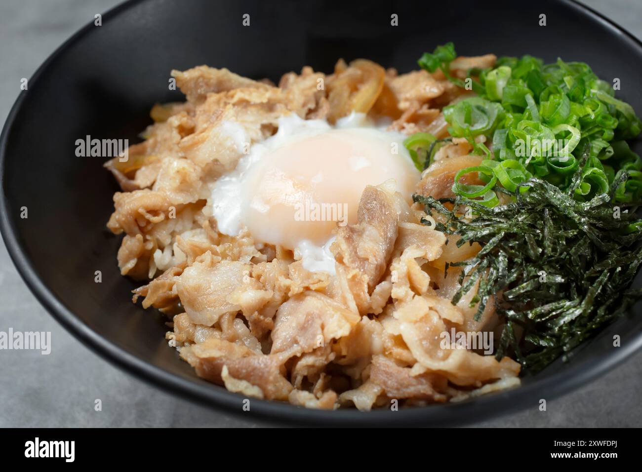 A view of a bowl of butadon Stock Photo - Alamy