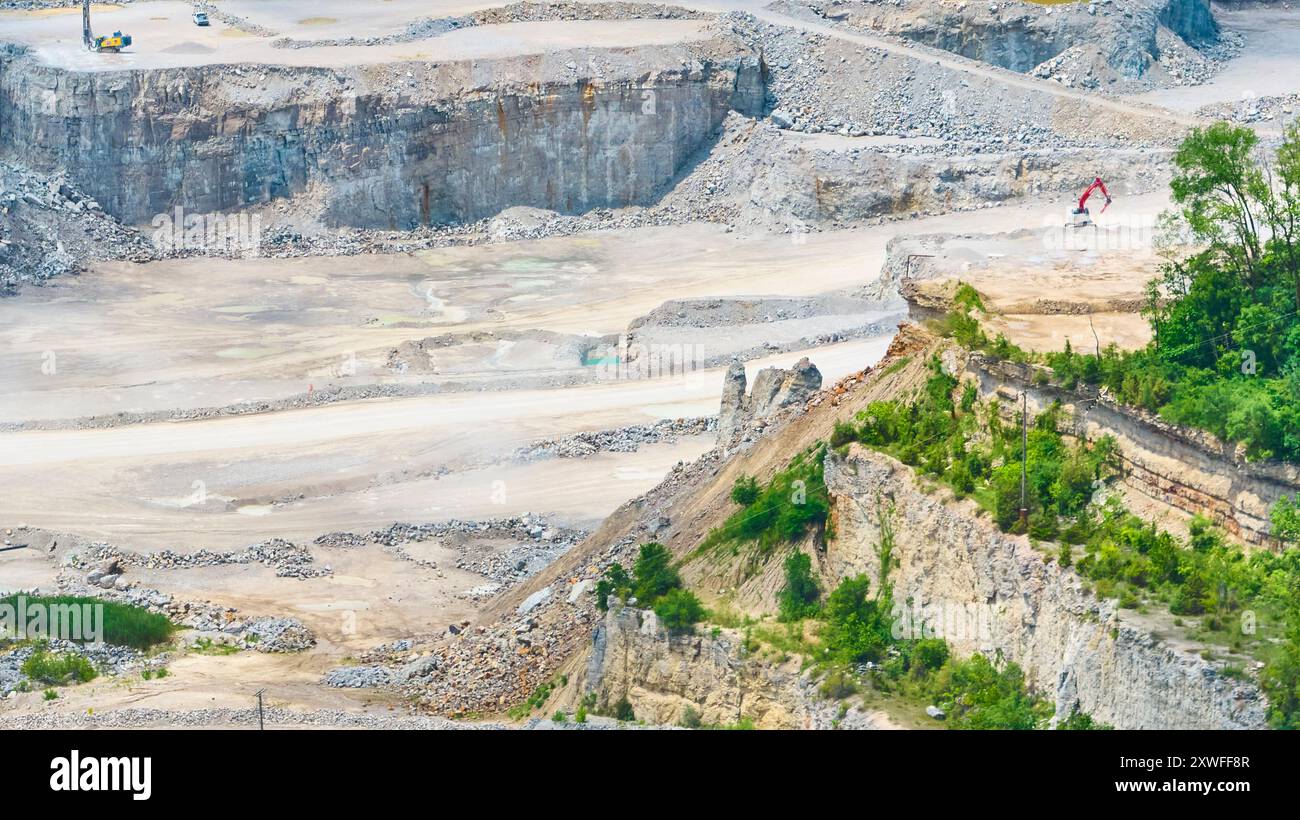 Aerial View of Large Quarry with Excavators and Terraced Rock Walls ...