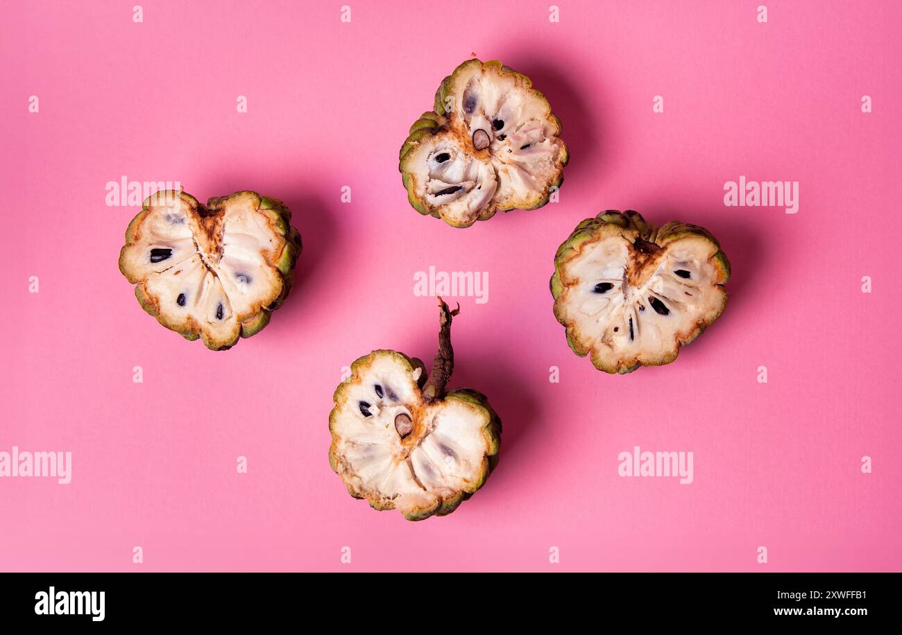 Custard apple fruit on a pink background Stock Photo - Alamy
