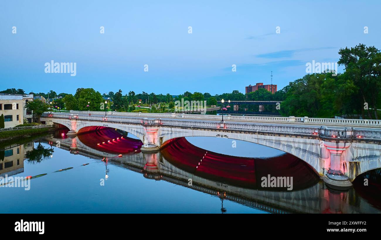 Aerial Fly Over Lit Bridge Reflecting on River at Blue Hour Stock Photo ...