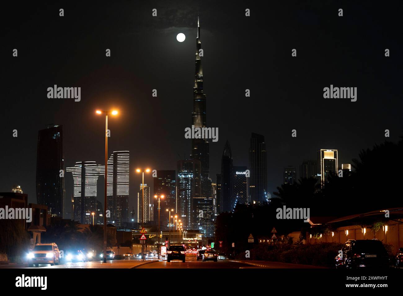 A supermoon rises behind the Burj Khalifa, world's tallest tower in ...