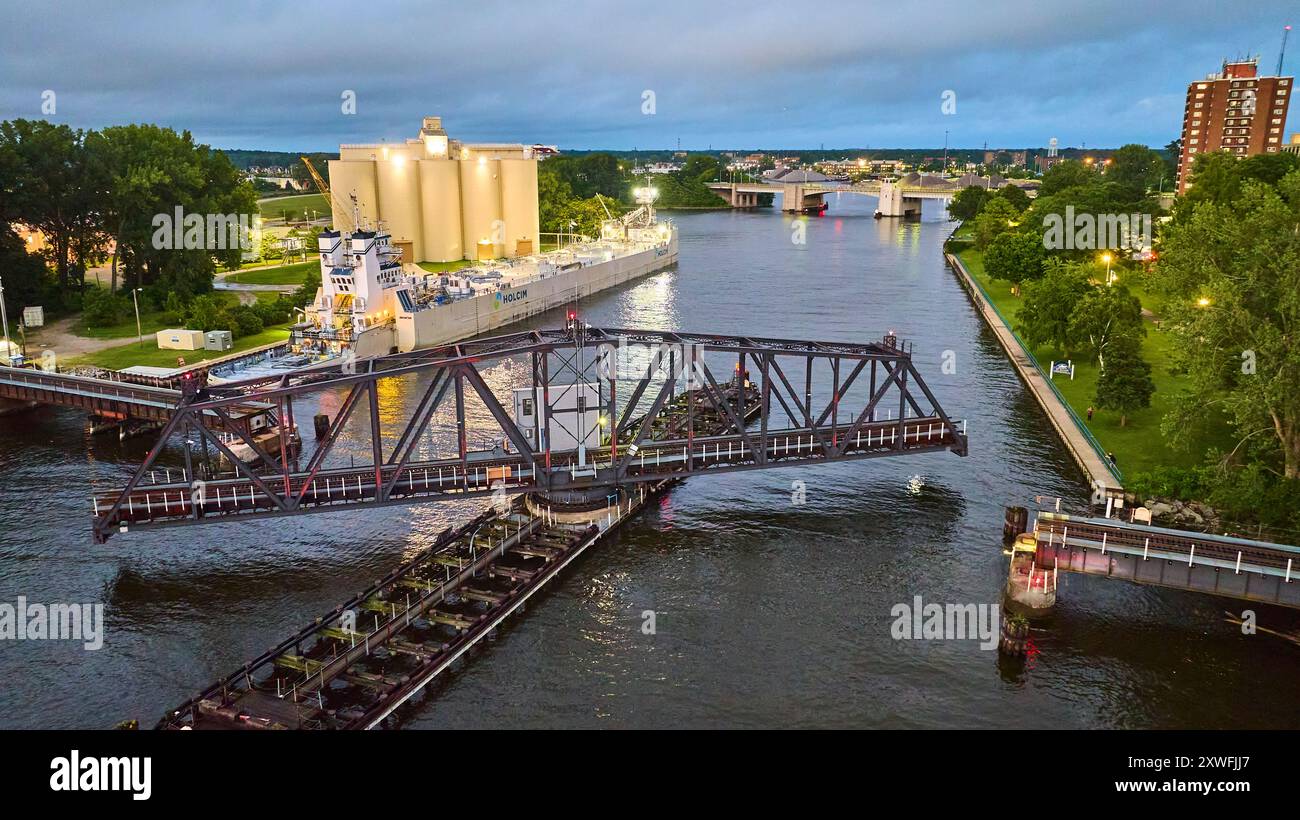 Aerial View of Cargo Ship by Swing Bridge and Silos at Dusk Stock Photo ...