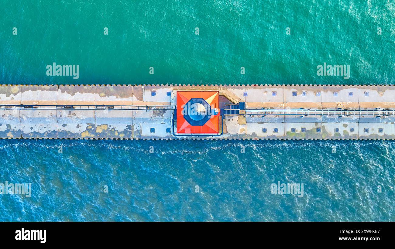 Aerial Top Down View of Red-Roofed Lighthouse on Concrete Pier in Lake ...