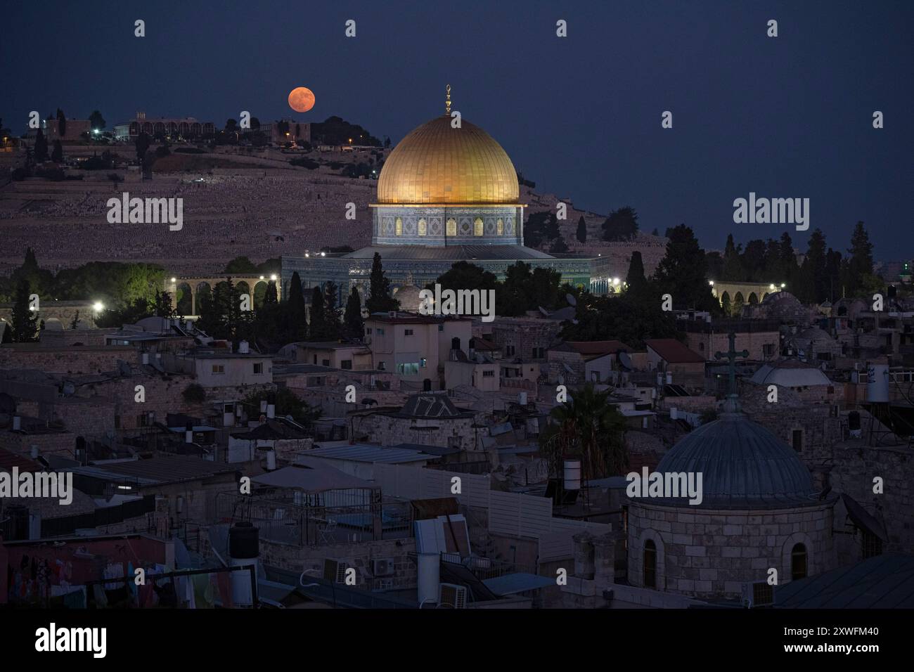 The super moon rises behind the Dome of the Rock shrine at the Al Aqsa ...