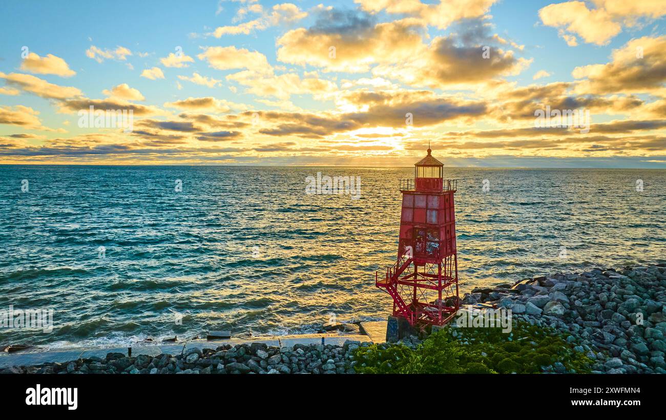 Aerial View of Red Lighthouse at Sunrise on Rocky Shore of Lake ...