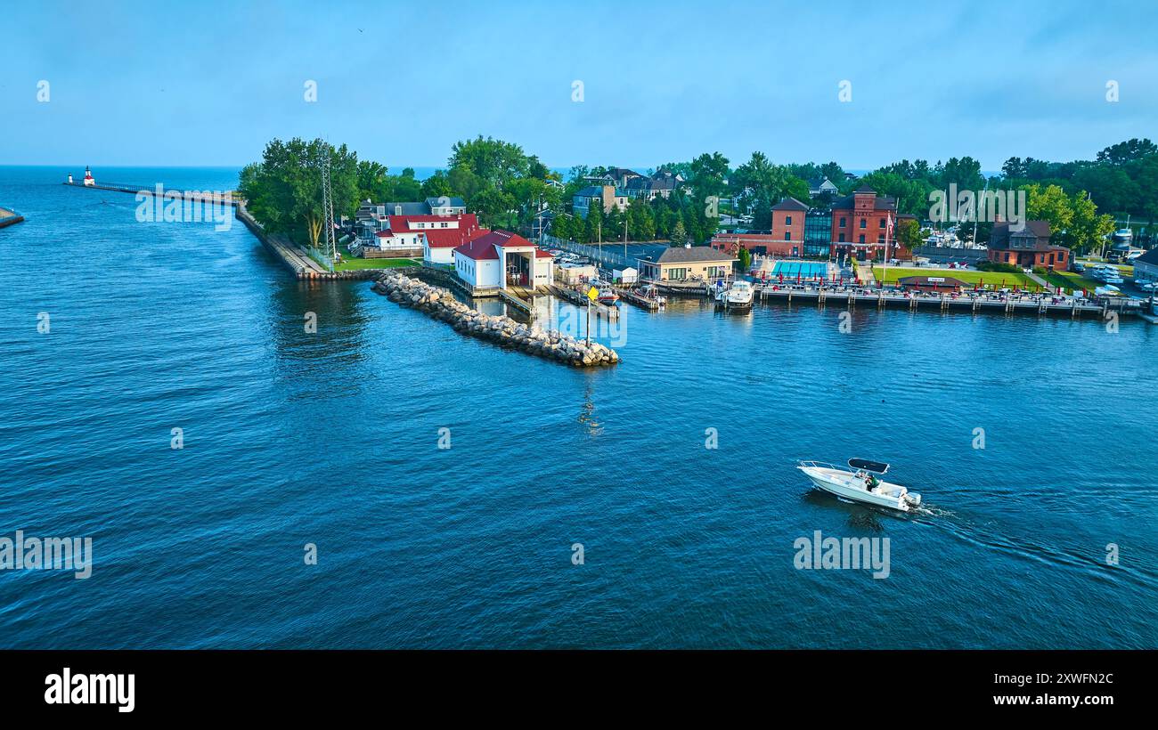 Aerial View of Quaint Harbor Town with Lighthouse and Motorboat Stock ...