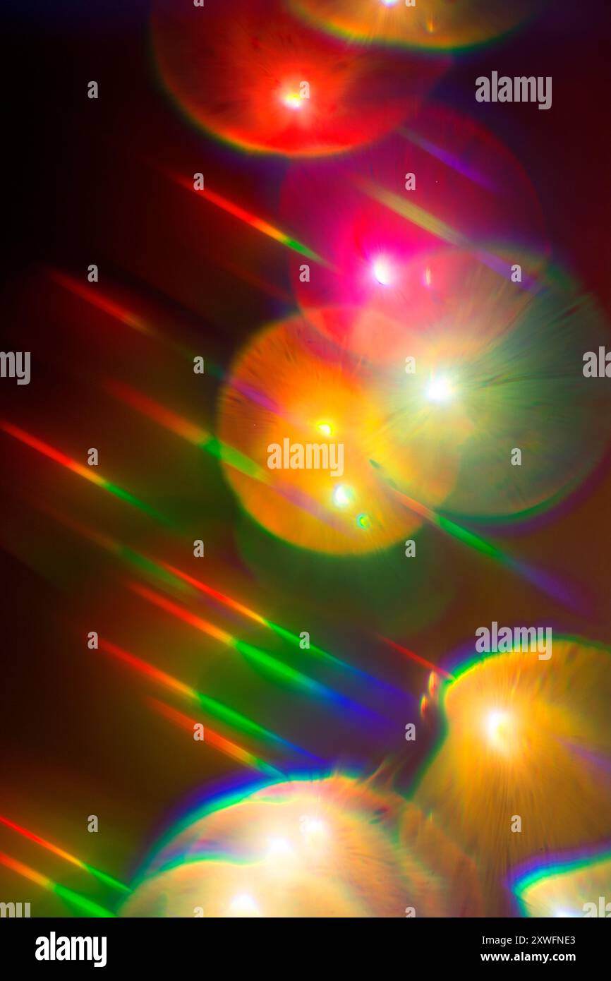 Out of focus Christmas lights, colourful with flare and rainbow colours ...