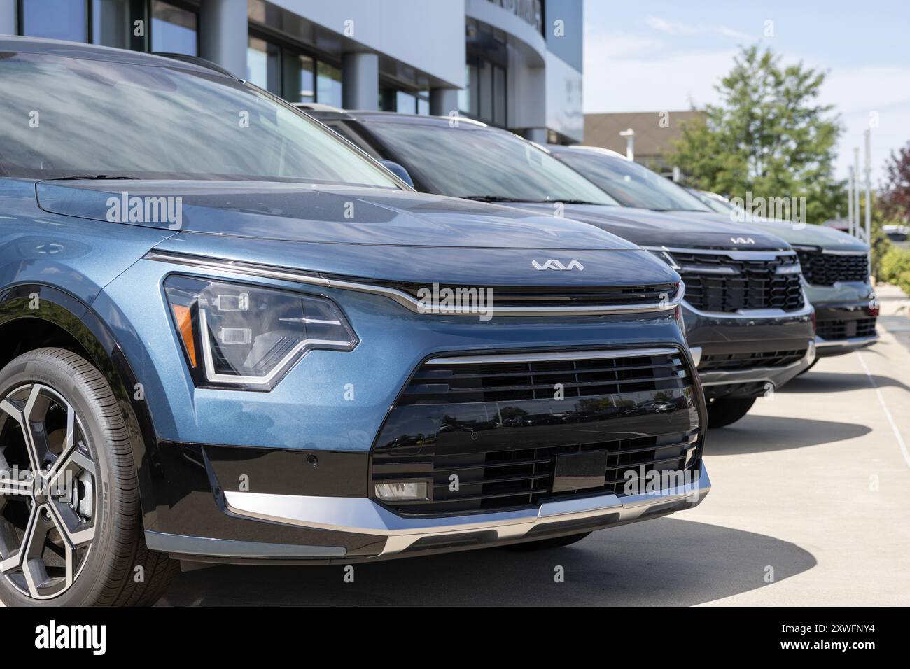 Avon - August 11, 2024: Kia car, SUV and EV dealership. Kia EV and gas ...