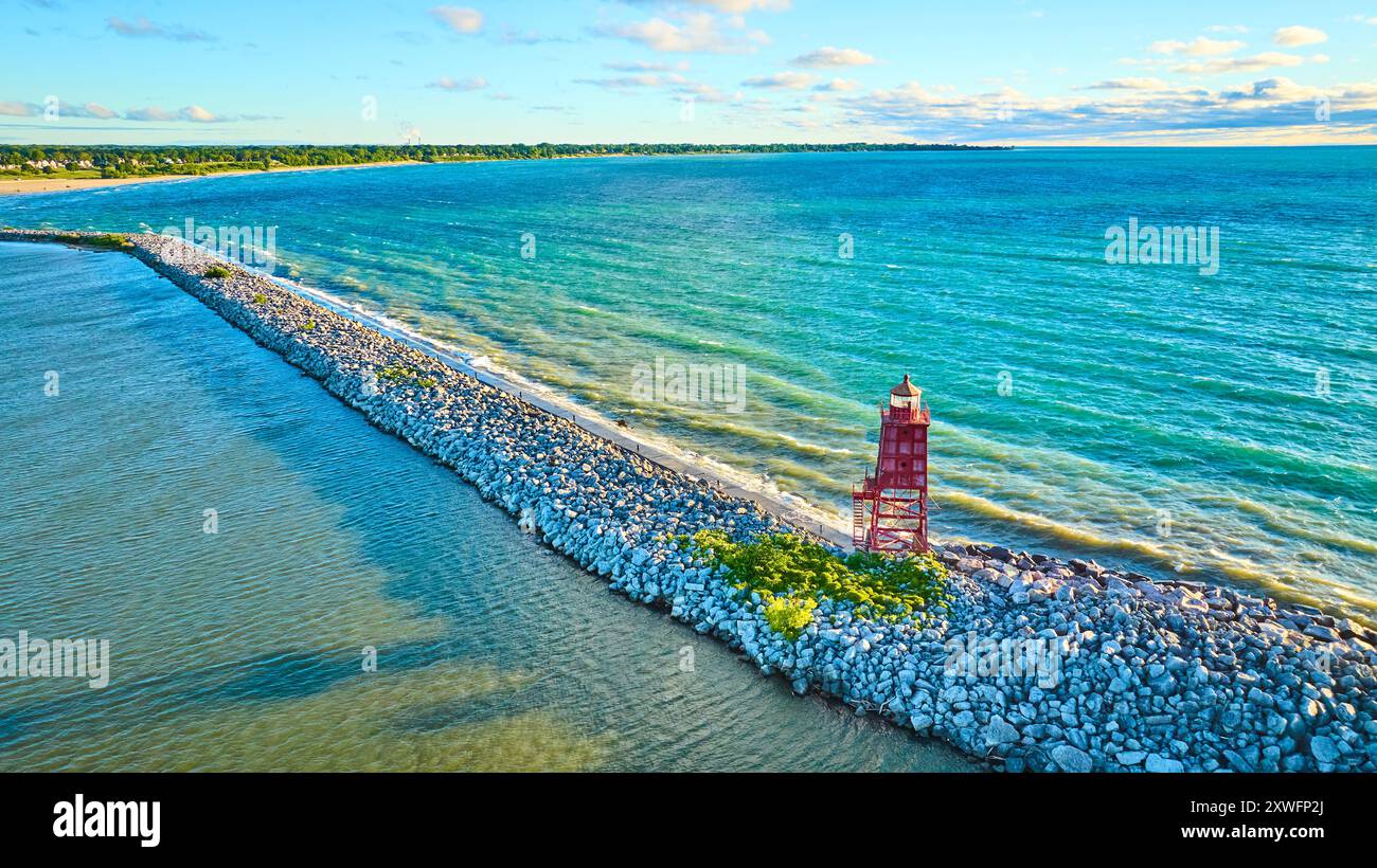 Aerial View of Red Lighthouse on Rocky Breakwater at Golden Hour Stock ...