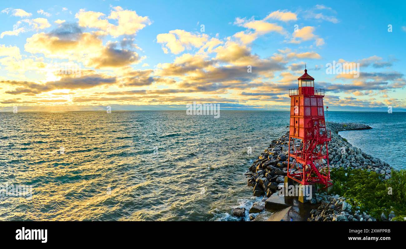 Aerial View of Red Lighthouse on Rocky Jetty at Sunrise Stock Photo - Alamy