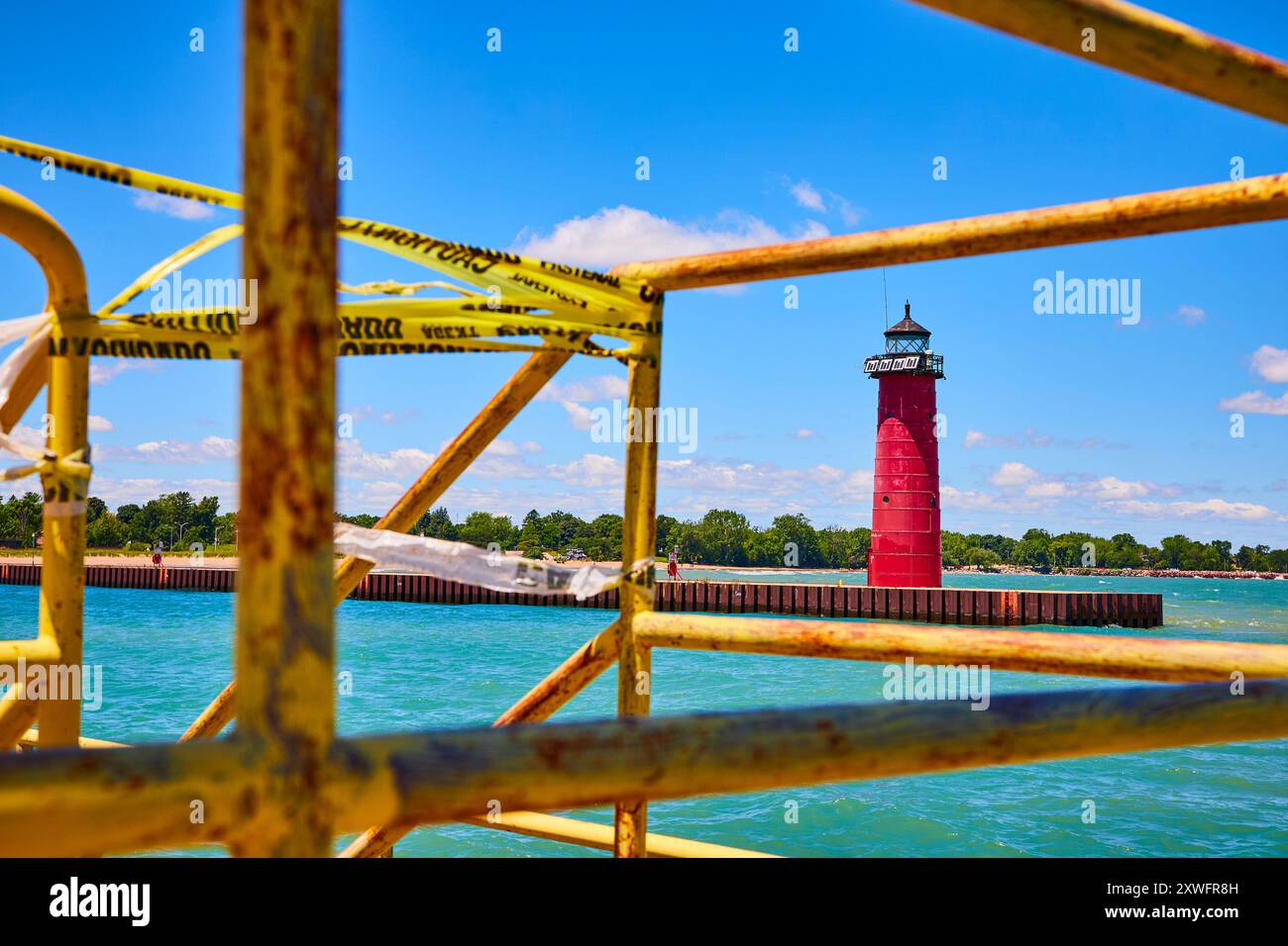 Red Lighthouse on Pier with Caution Tape Framing - Eye Level View Stock ...