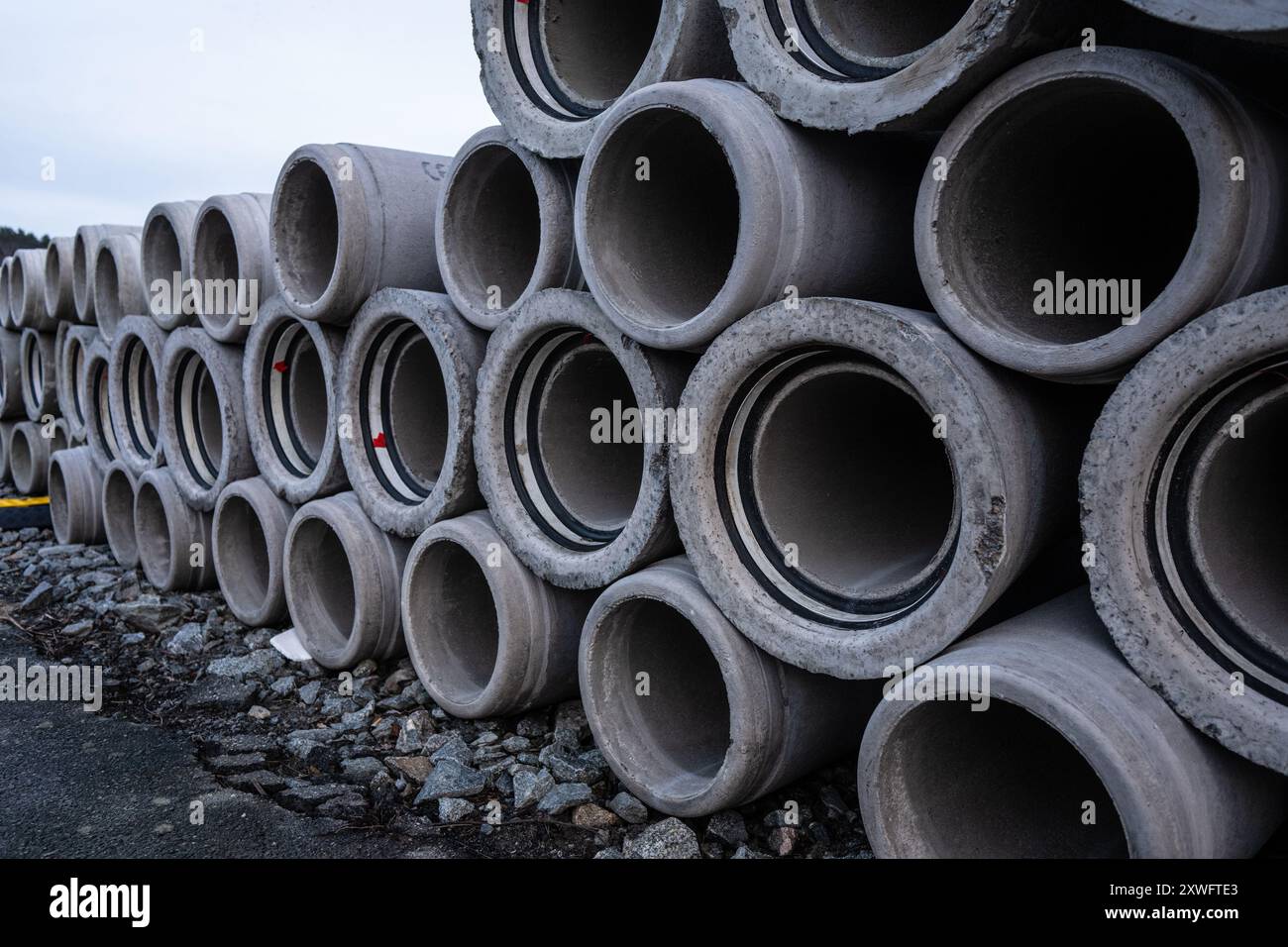 Large pile of concrete drain pipes at a construction site Stock Photo ...