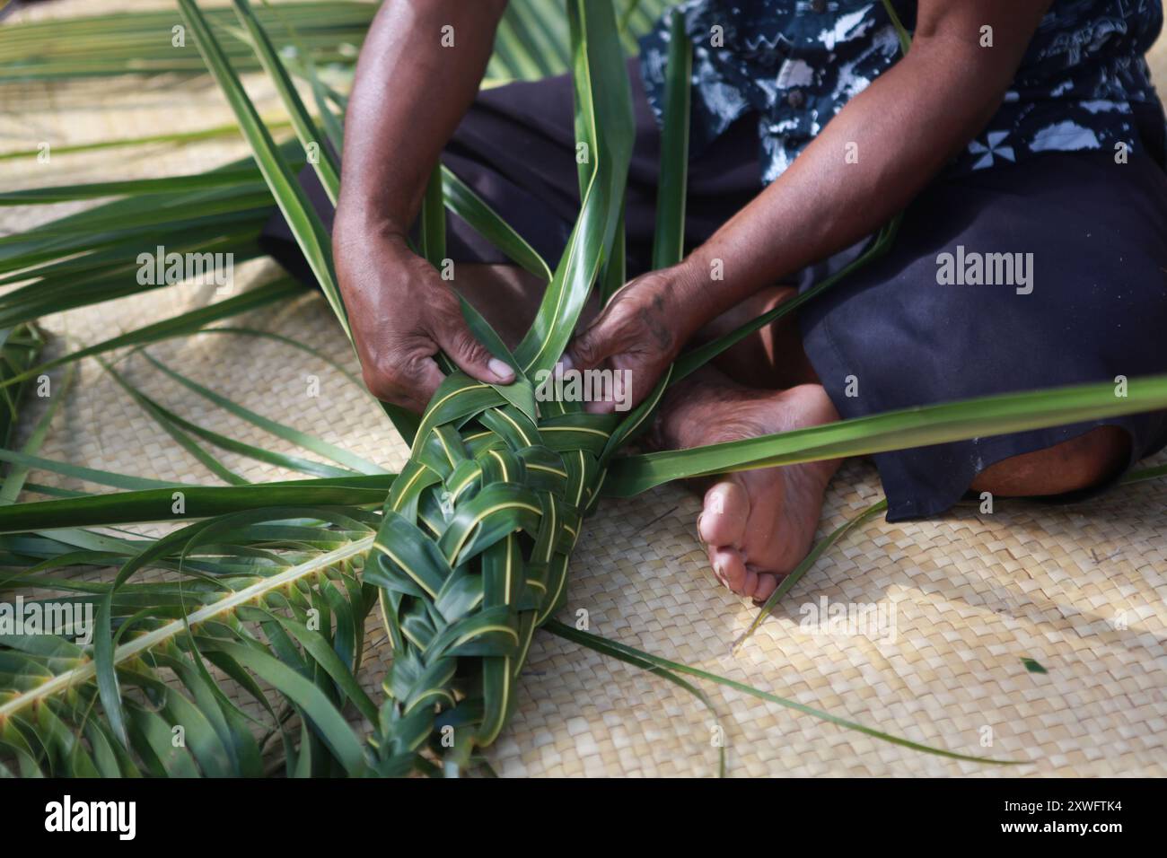 Fijian traditional basket weaving from palm leaves, men's basket ...