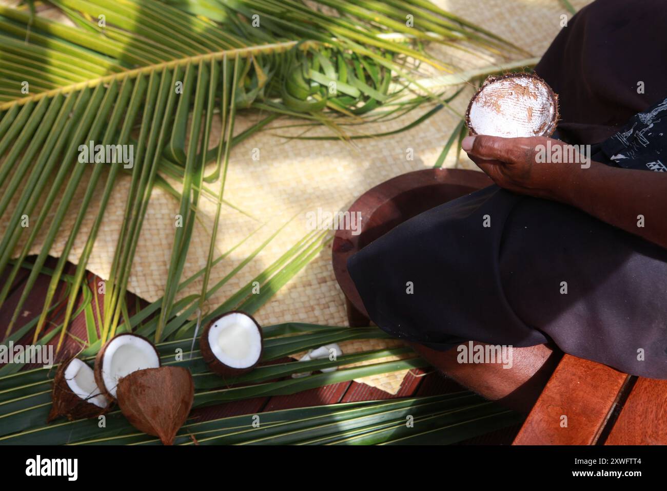 Scraping fresh coconut, traditional food demonstration, Fiji Stock ...