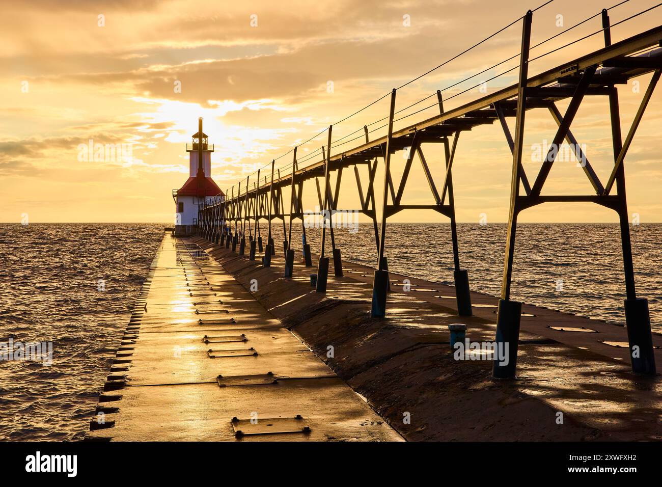 Golden Hour Lighthouse on Pier with Calm Waters at Eye Level Stock ...