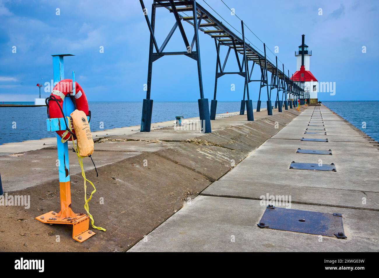 Red and White Lighthouse on Concrete Pier with Life Ring Perspective ...