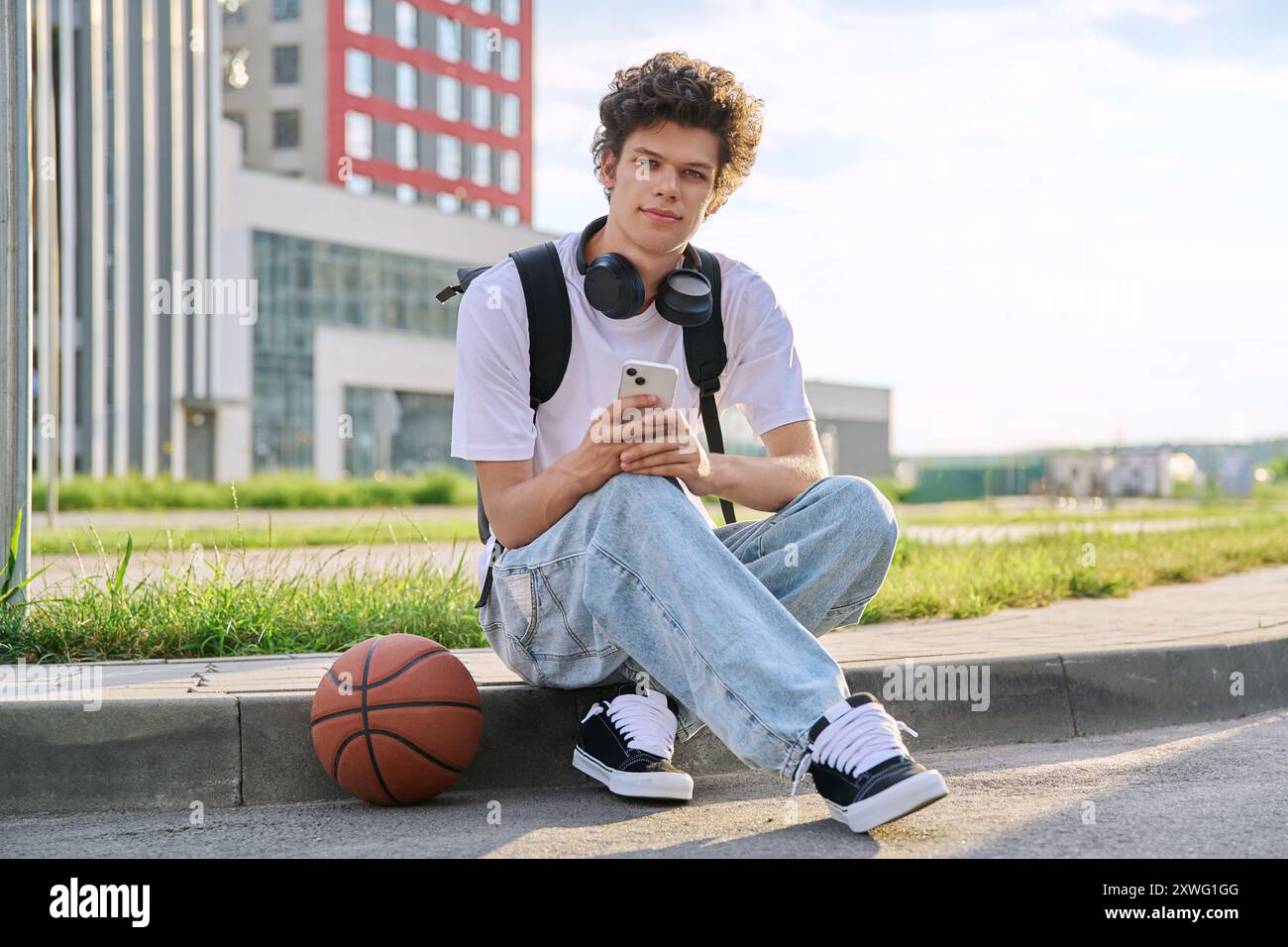 Portrait of 19, 20 year old handsome smiling student guy, outdoors ...