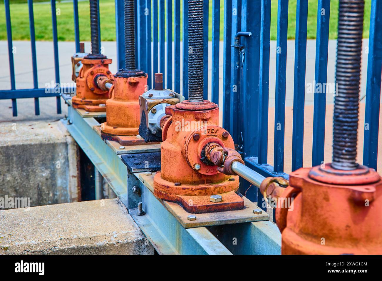 Rusted Industrial Gate Valves Aligned on Metal Beam Eye-Level View ...