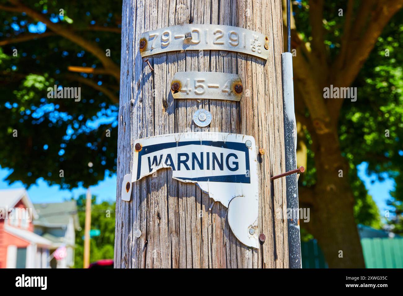 Weathered Utility Pole with Warning Sign in Suburban Neighborhood ...