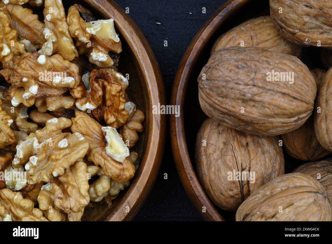 broken walnuts and nutcracker on black background Stock Photo - Alamy