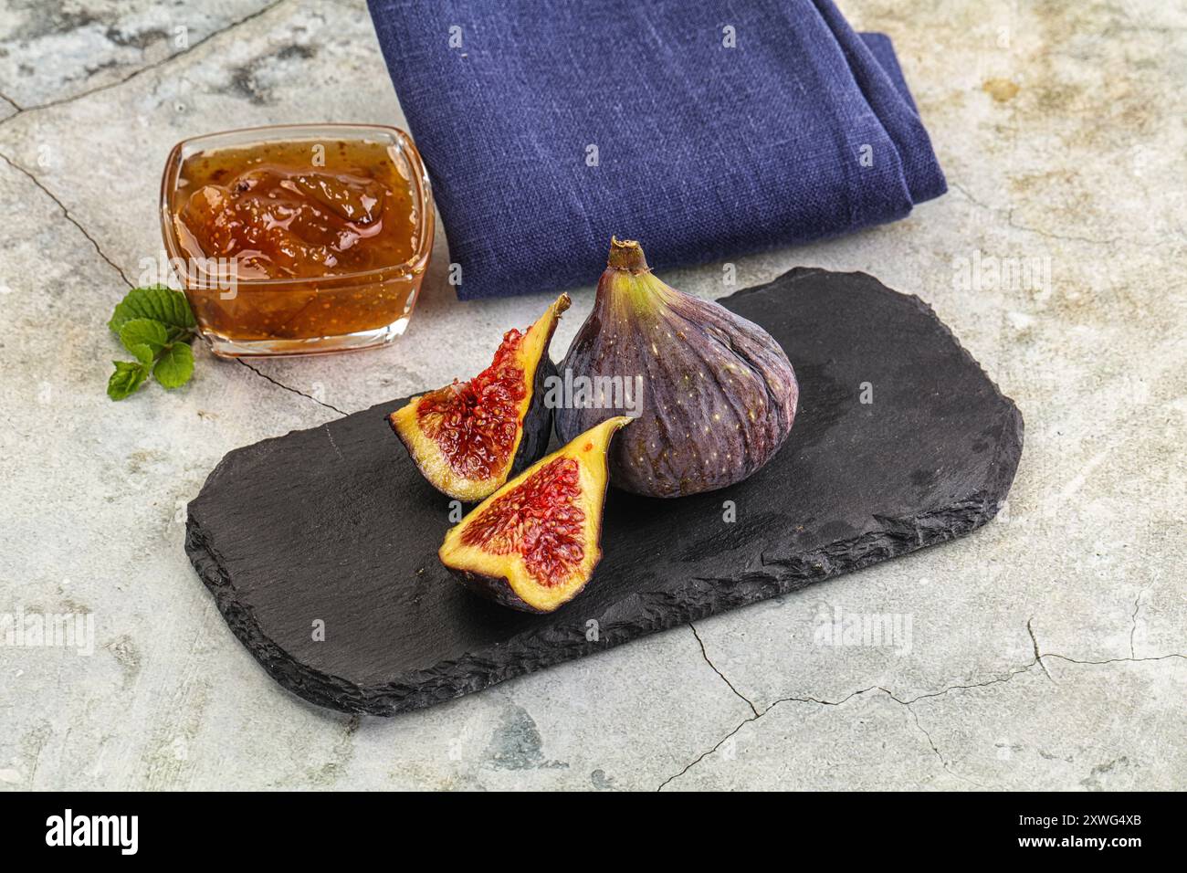 Purple ripe sweet fig with cut Stock Photo - Alamy