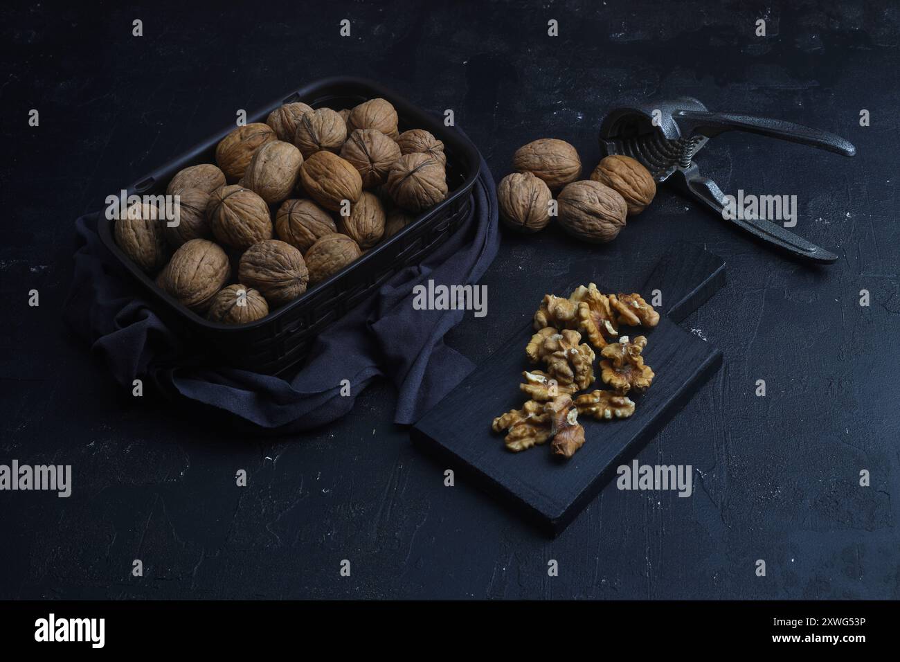 Walnuts and a steel nutcracker isolated on white Stock Photo - Alamy