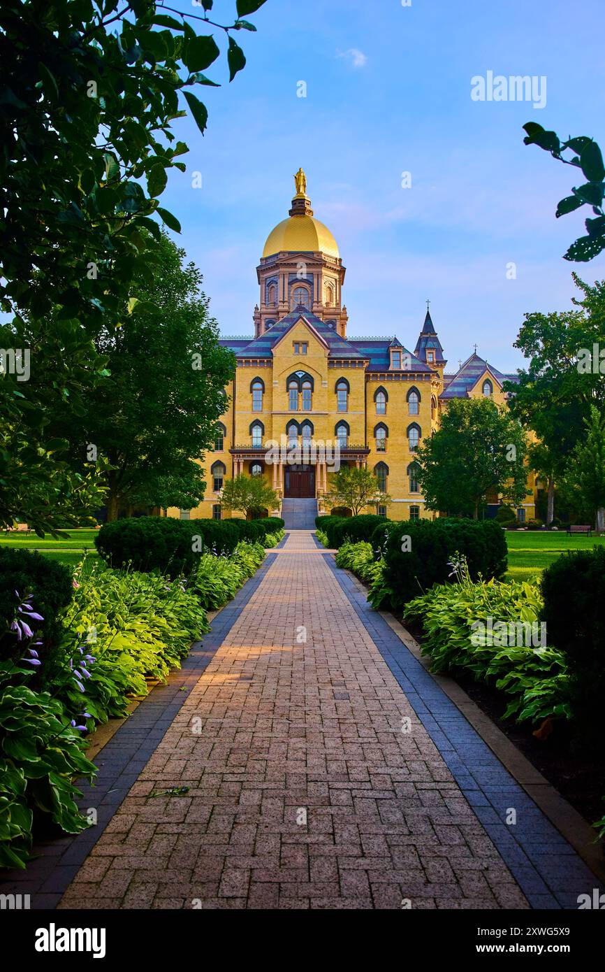 Historic University Building with Golden Dome and Garden Pathway ...
