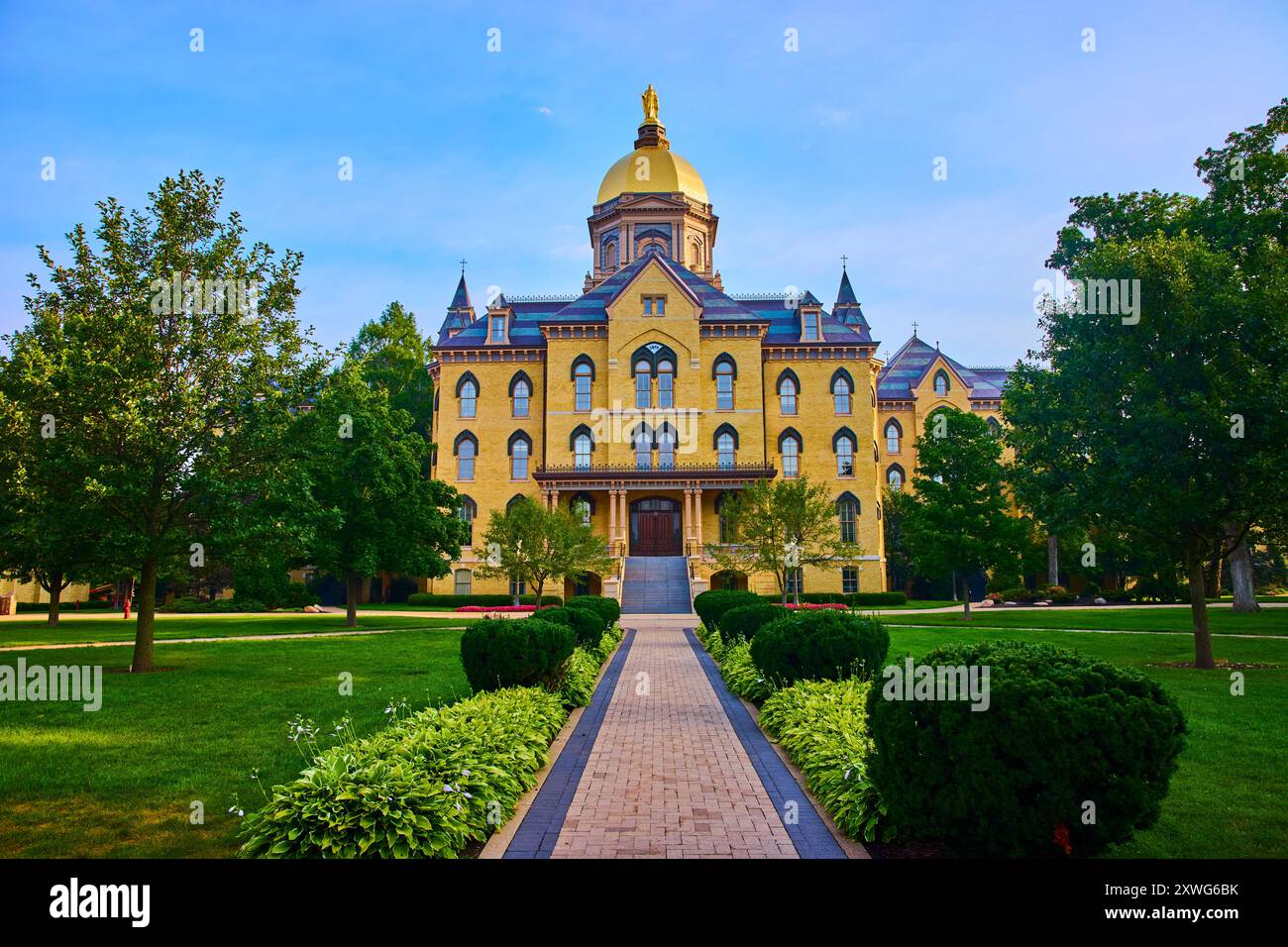 Historic University Building with Golden Dome and Pathway Perspective ...