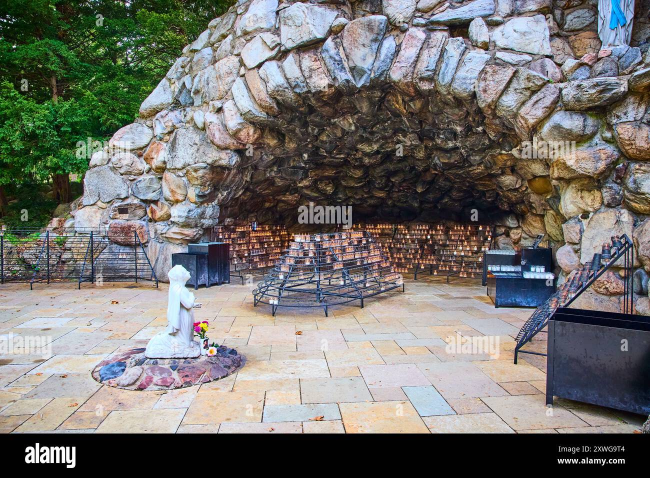 Grotto with Candles and Statue of Kneeling Figure Eye Level Perspective ...