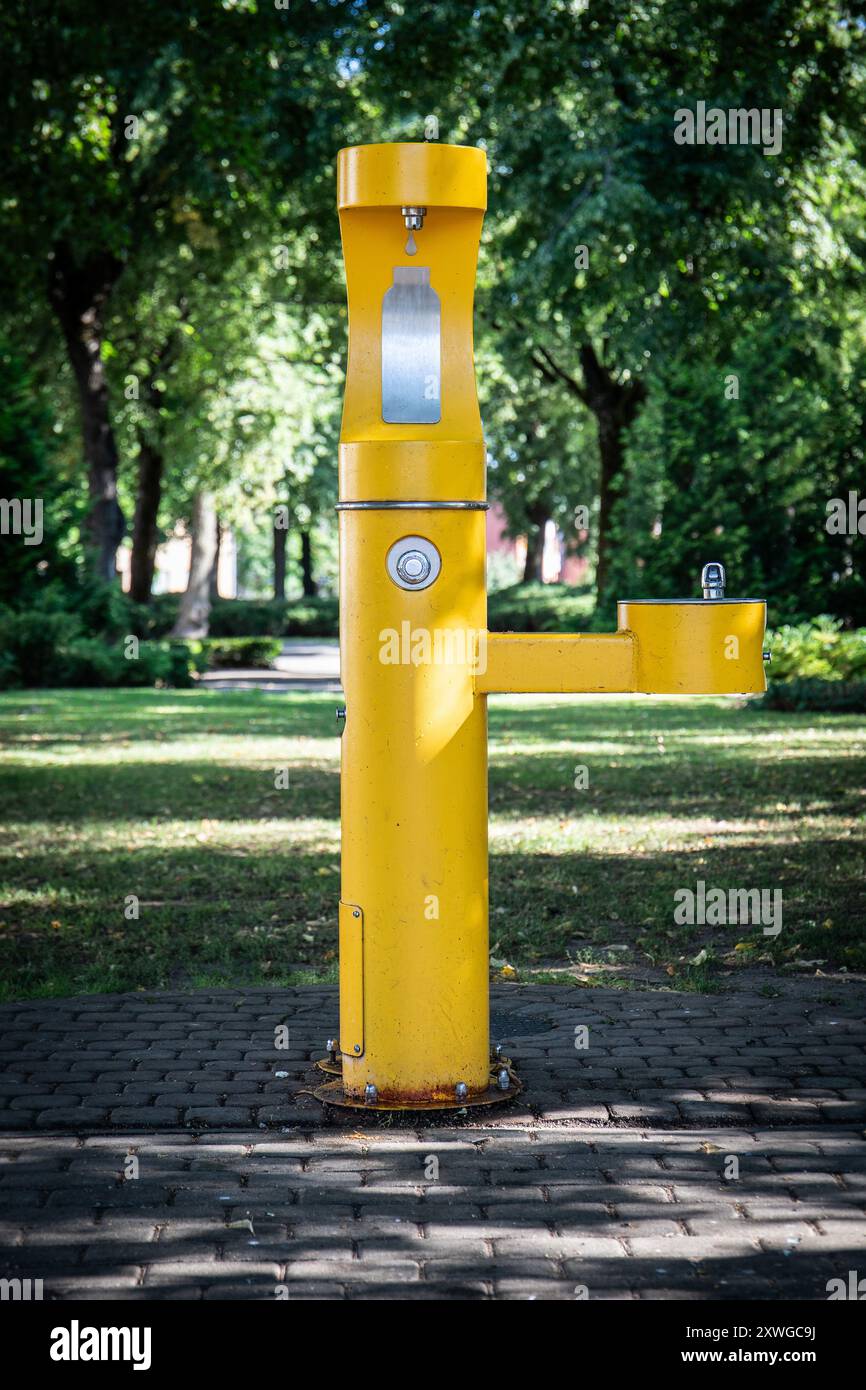 Yellow public drinking water tap, urban infastructure Stock Photo - Alamy