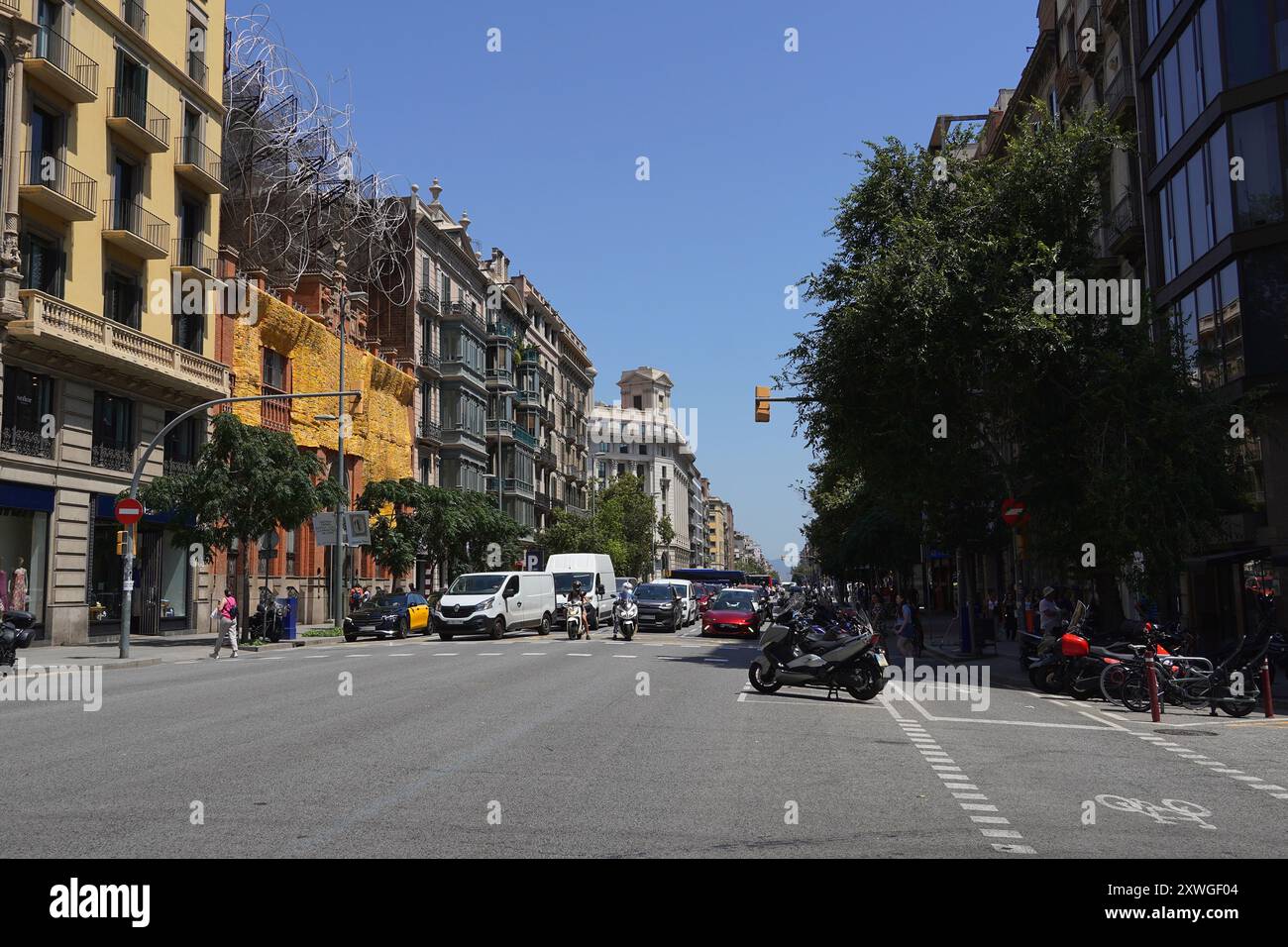 July 18, 2024, Barcelona, Spain. View of a busy city street and the ...