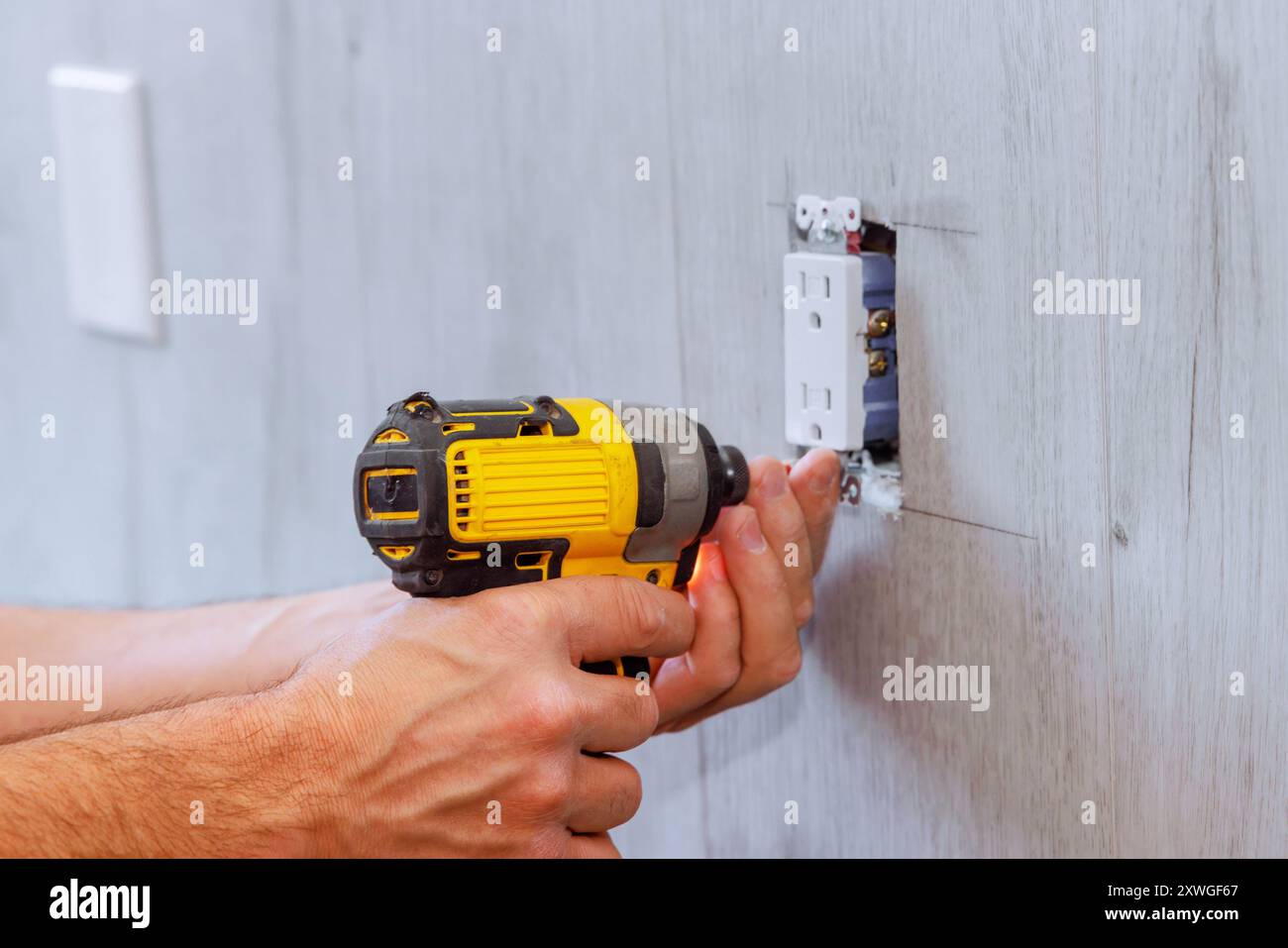 During reconstruction of house, electrician installs an outlet using ...