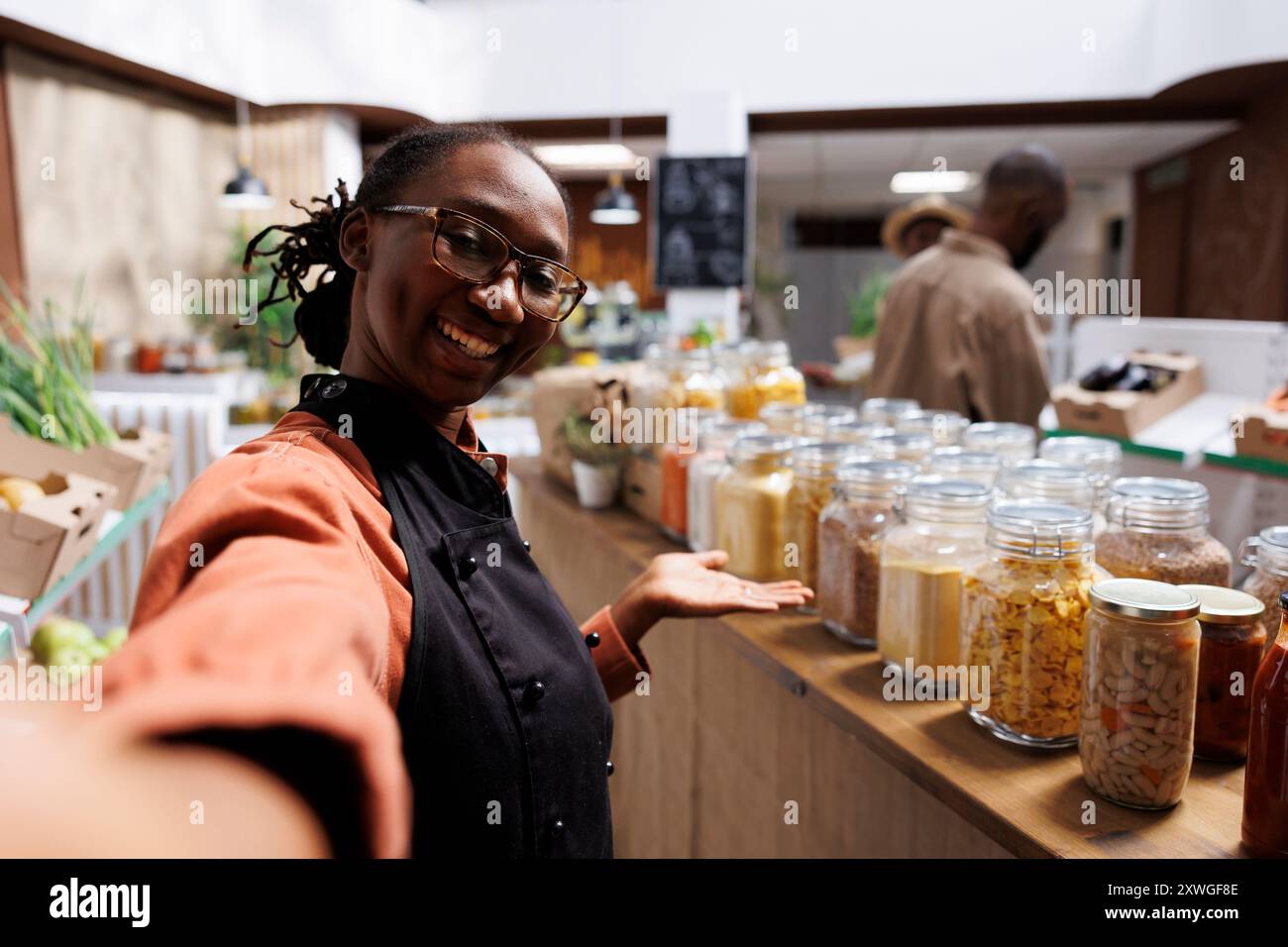 African woman in a market with her cell phone hi-res stock photography ...
