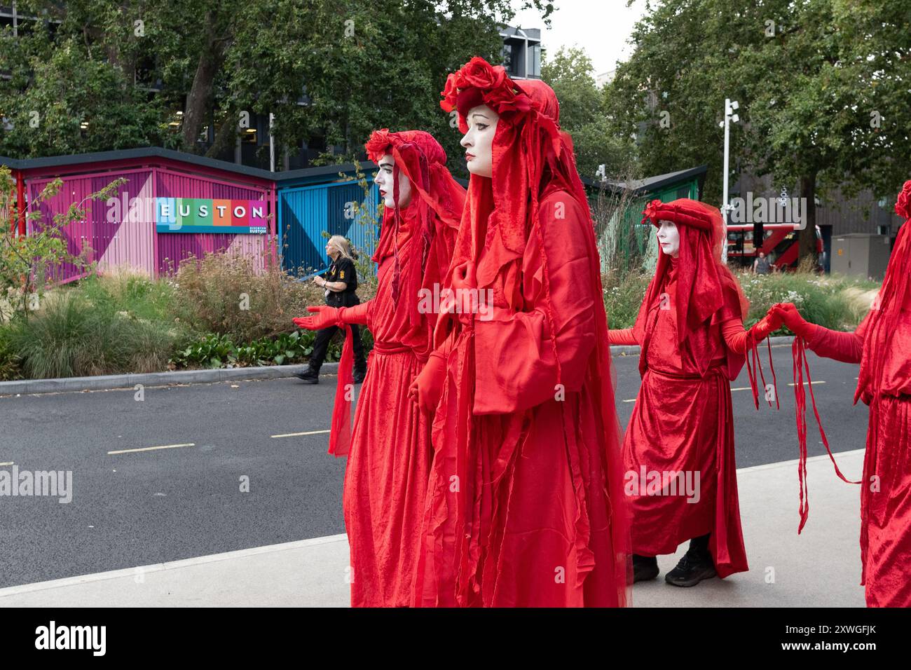 London, UK. 19 August, 2024. Extinction Rebellion's Red Rebel activist ...