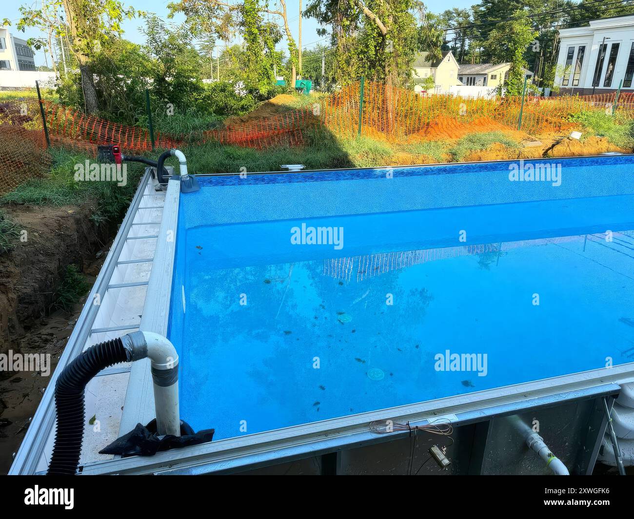 Swimming ground pool construction in backyard of near house Stock Photo ...