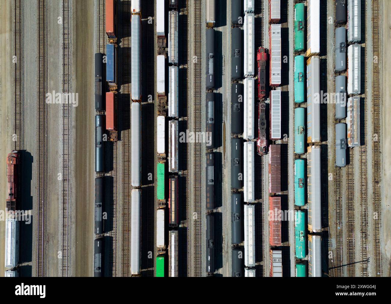 Employees move locomotives, right, as rail and tanker cars and shipping ...