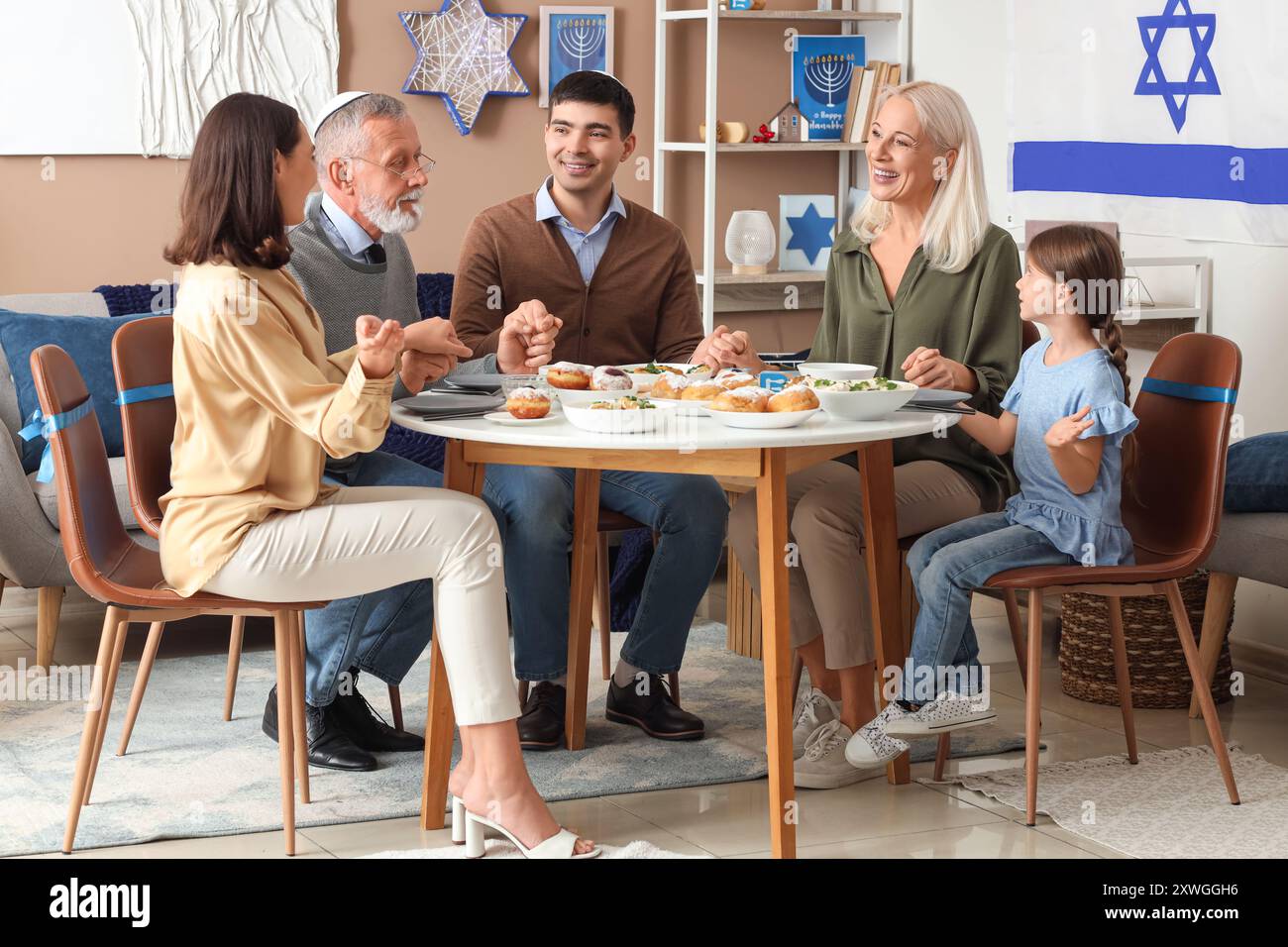 Happy Jewish family having dinner at home on Hanukkah Stock Photo - Alamy
