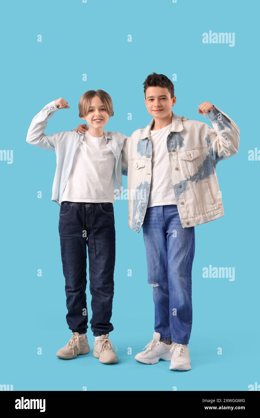 Happy brothers hugging on blue background Stock Photo - Alamy